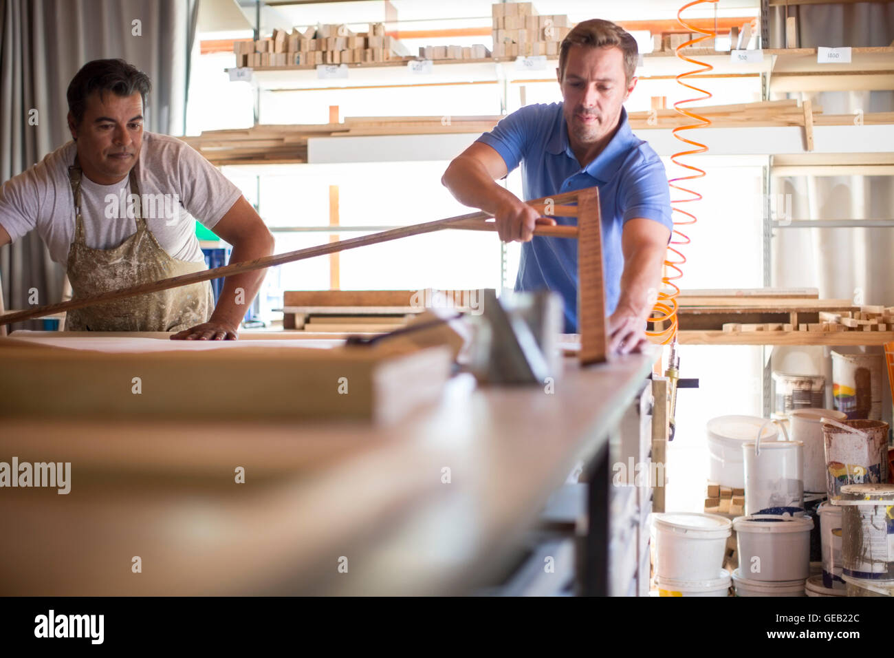 Two men working together in canvas workshop Stock Photo - Alamy