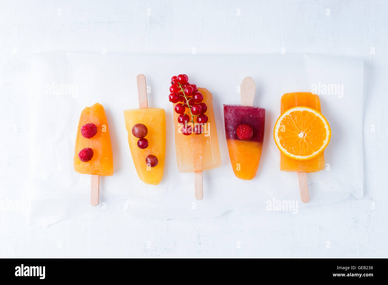 Fruits and different homemade ice lollies made of fruit juice and pulp ...