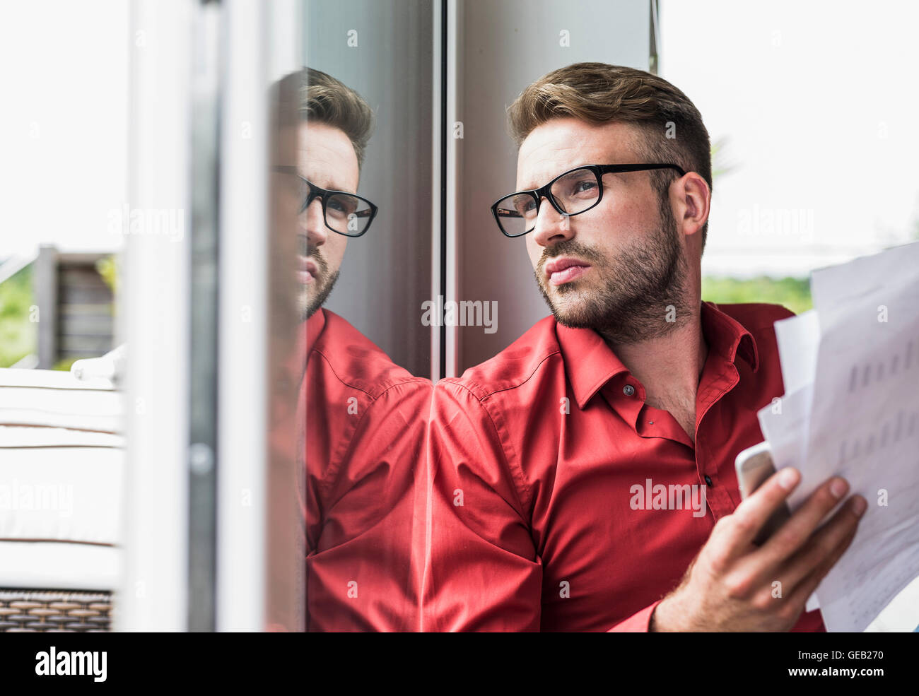 Serious businessman looking through documents hi-res stock photography ...