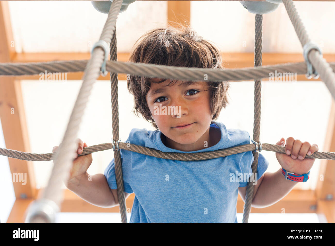 Portrait of little boy on hanging bridge of a playground Stock Photo ...