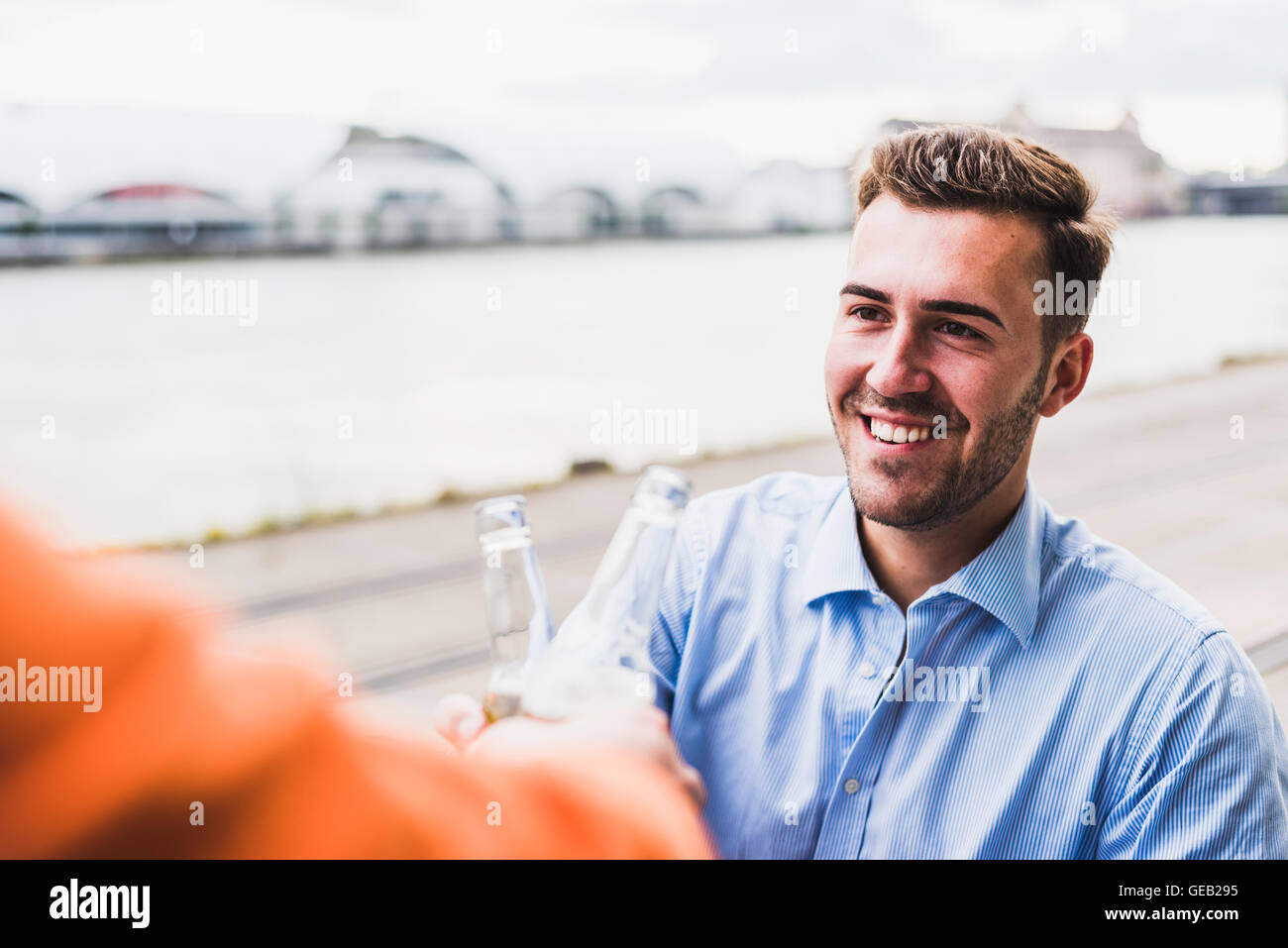 Two colleagues having a beer after work Stock Photo - Alamy