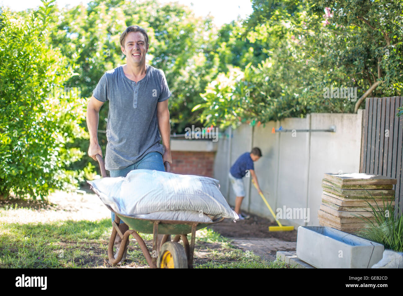 Father and son working together in garden Stock Photo - Alamy
