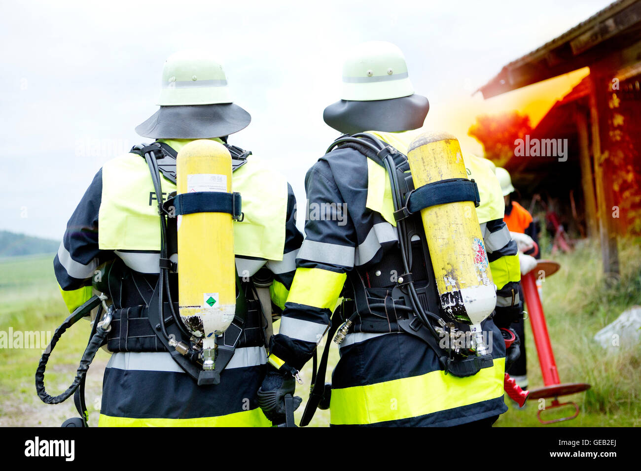 Back view of two firefighters Stock Photo - Alamy