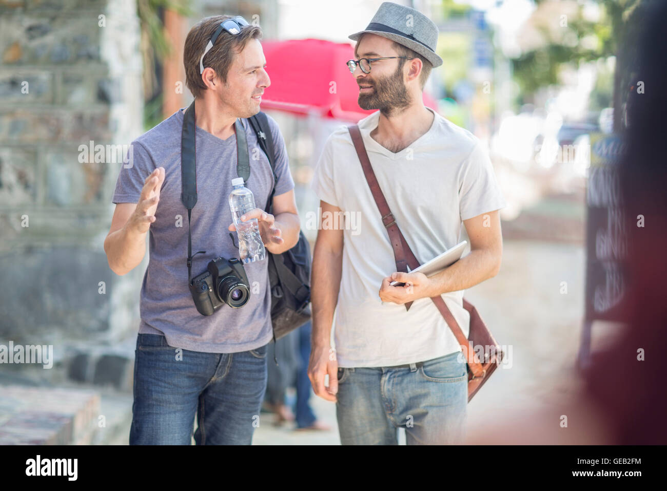 Two men walking and talking in the city Stock Photo - Alamy