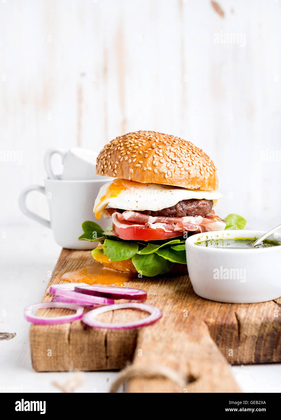 Breakfast set. Homemade beef burger with fried egg, vegetables, onion ...