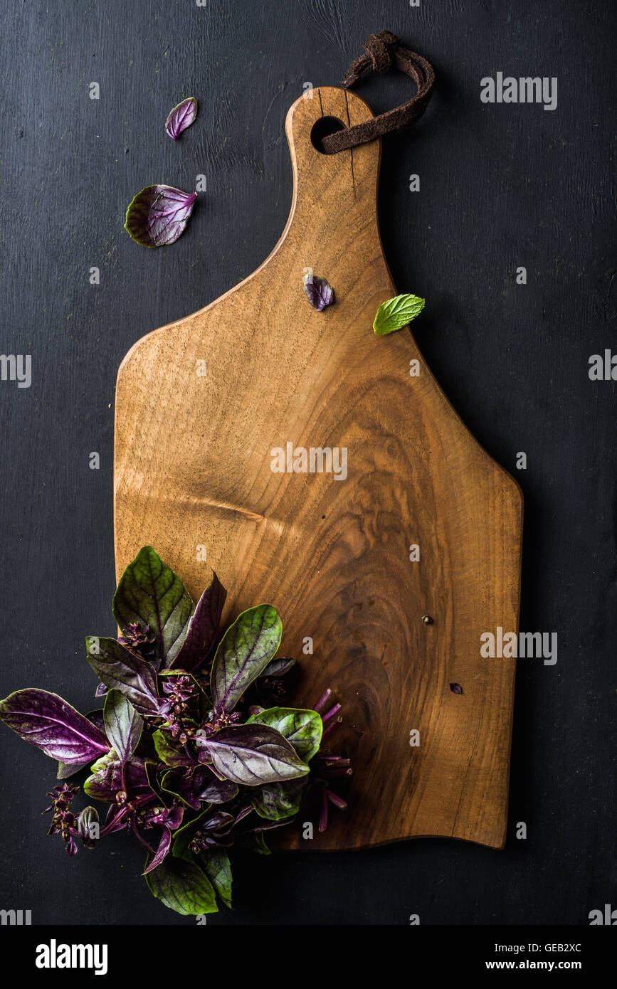 Violet basil bunch on wooden chopping board Stock Photo - Alamy