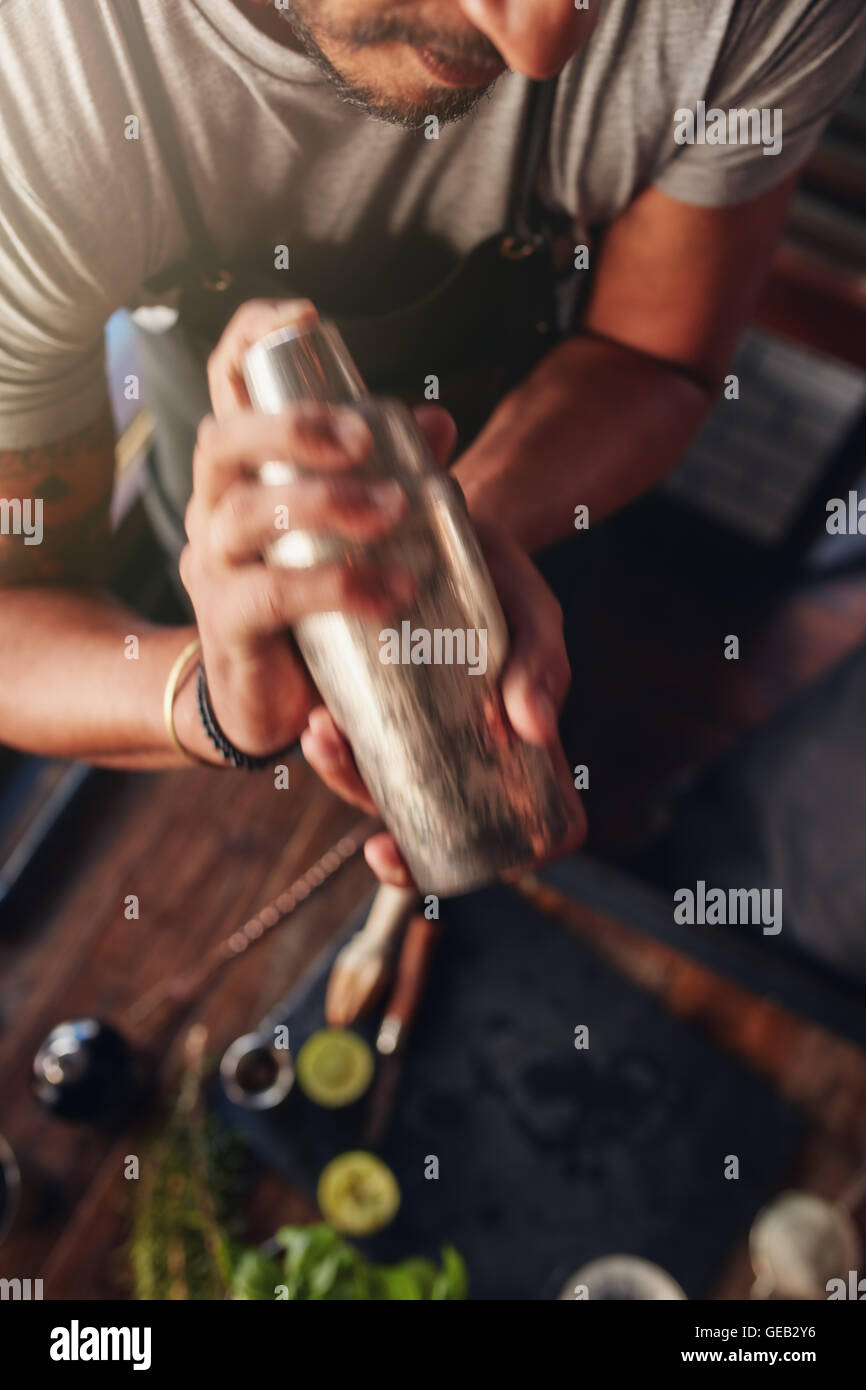 Close up shot of male bartender mixing drink in cocktail shaker Stock ...