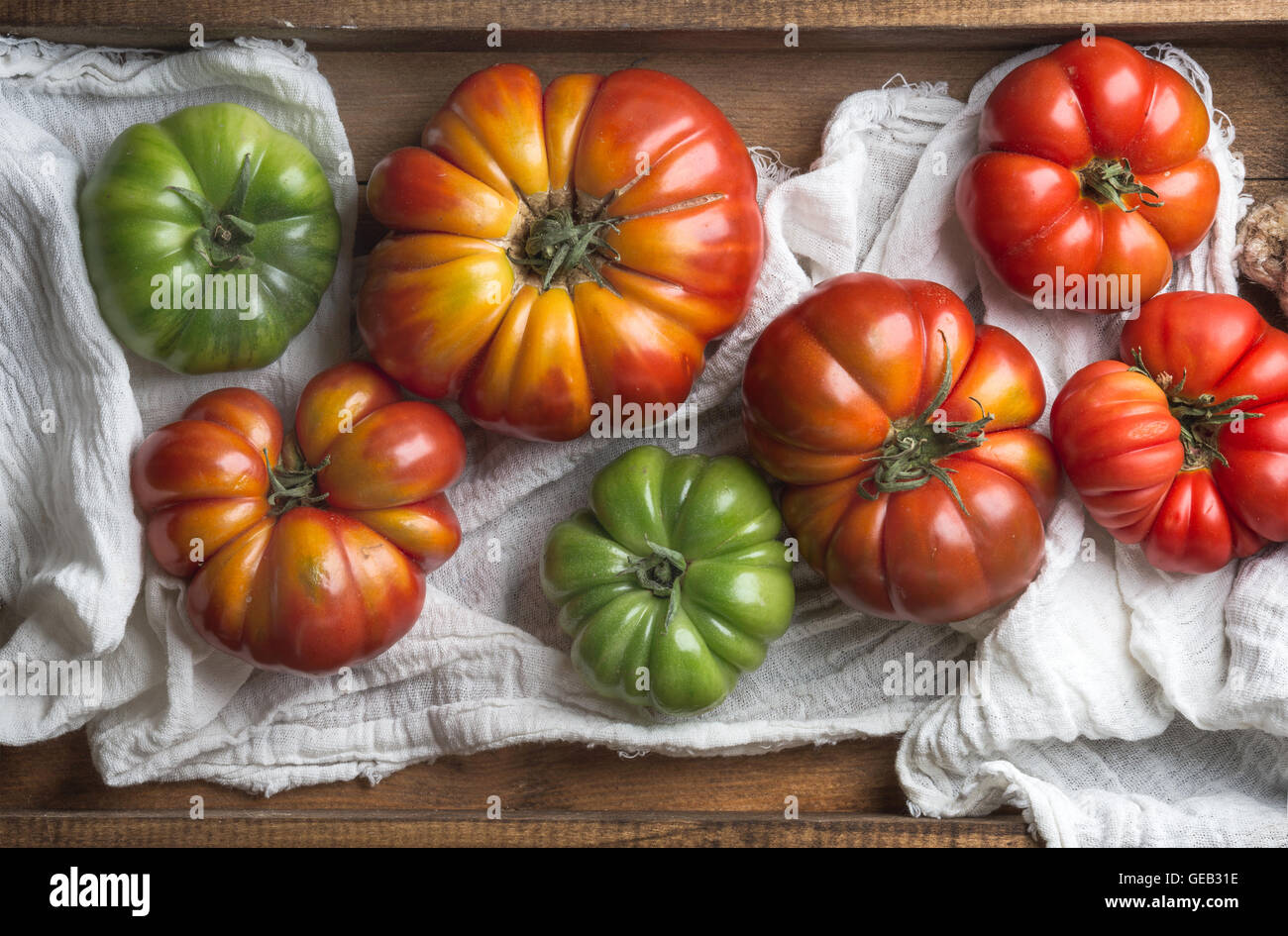 Colorful Heirloom tomatoes in rustic wooden tray Stock Photo - Alamy