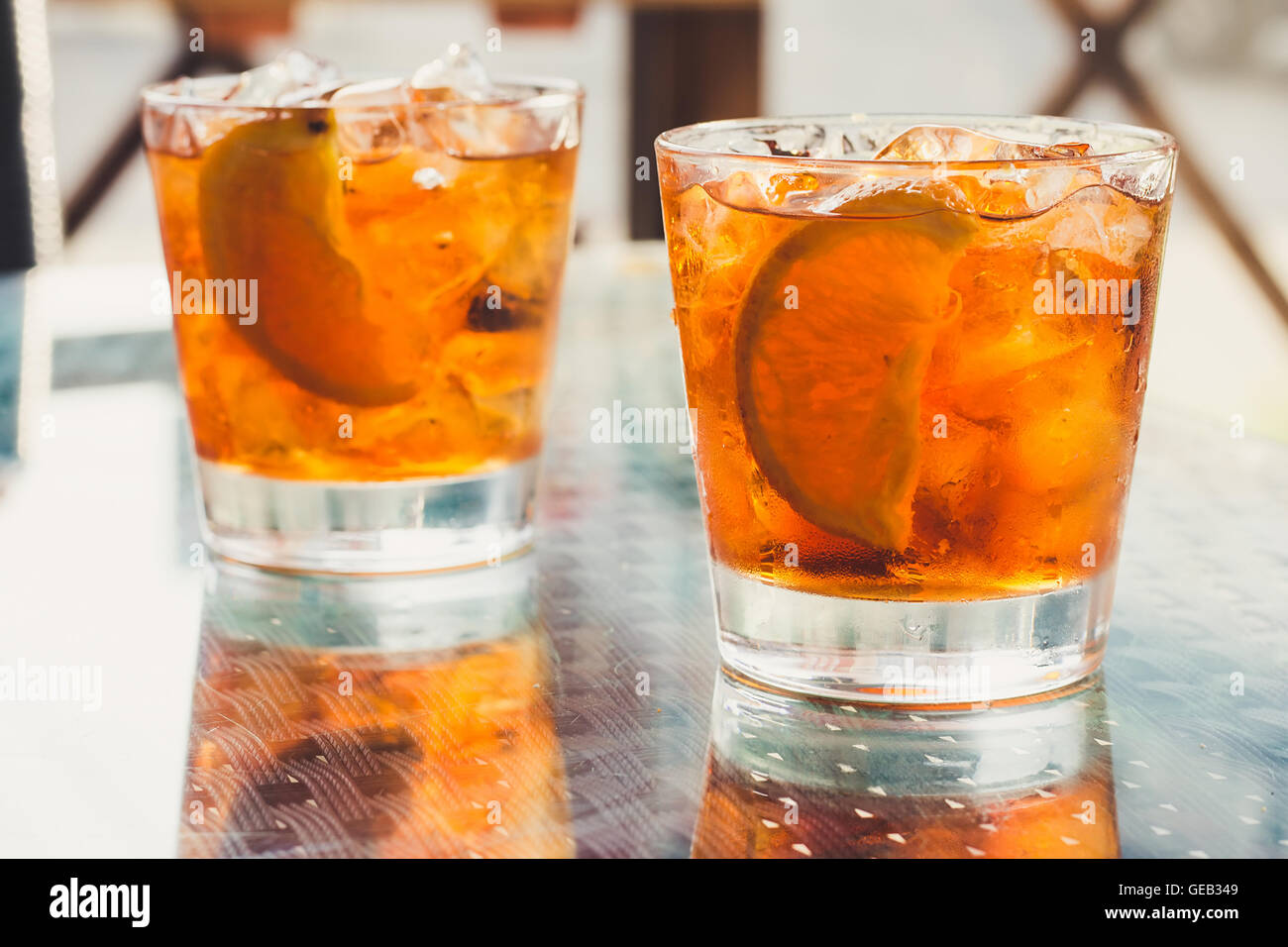 Two cocktails boulvardier on glass table selective focus Stock Photo ...
