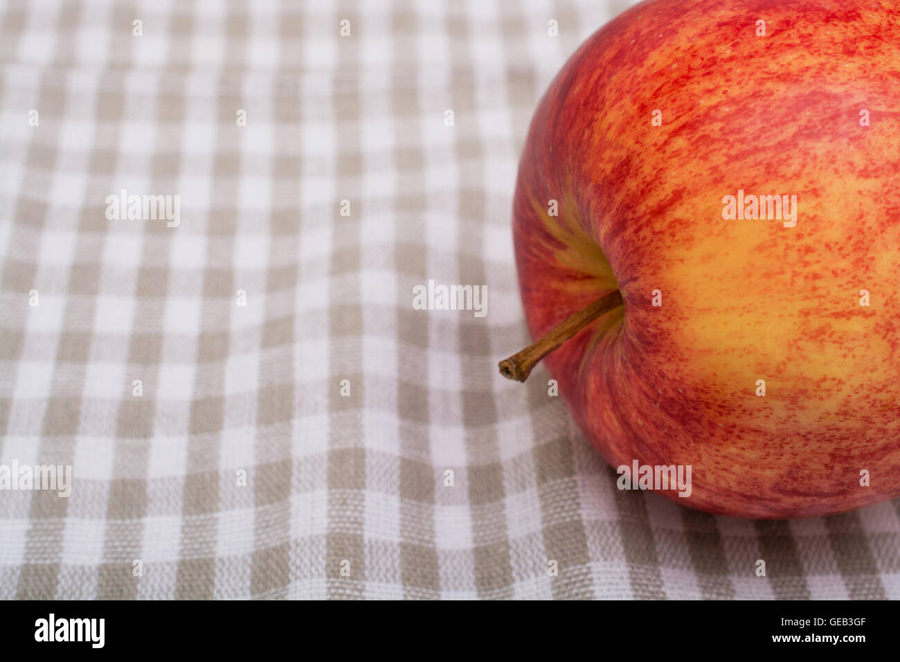 Red ripe apple on tablecloth Stock Photo - Alamy