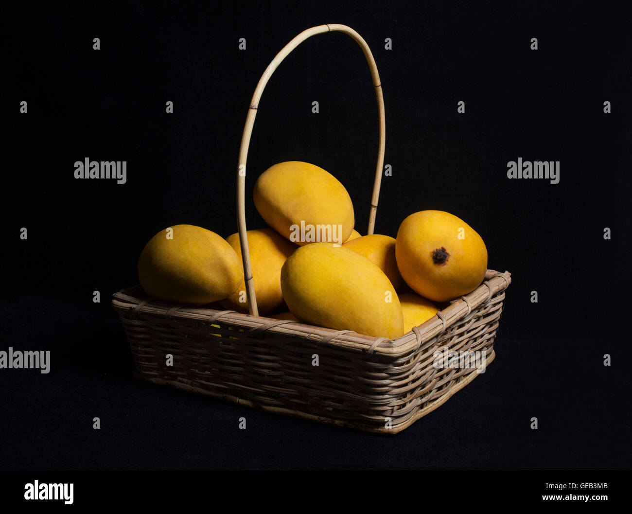 Fresh ripe chaunsa mangoes with basket on black background Stock Photo ...