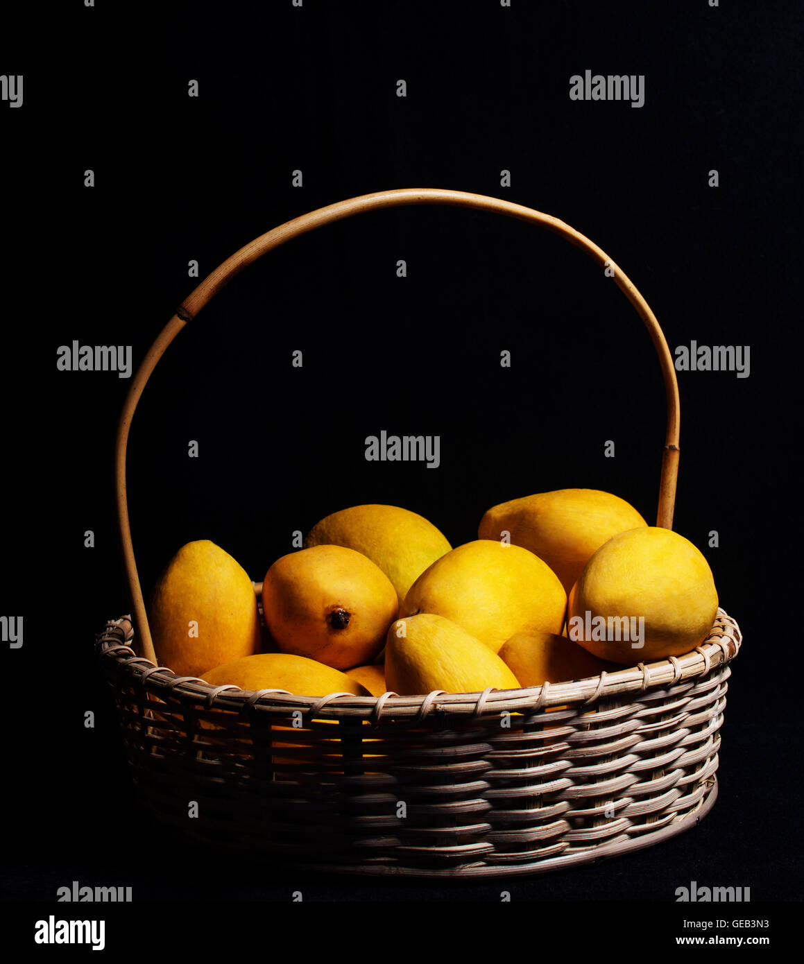 Fresh ripe chaunsa mangoes with basket on black background Stock Photo ...