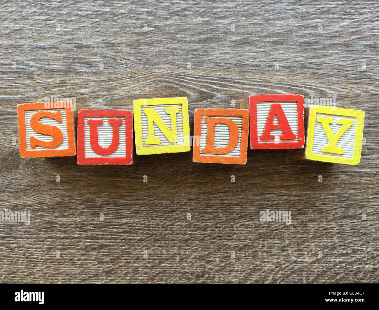 Alphabet wood block letters forming the word SUNDAY, combining those ...