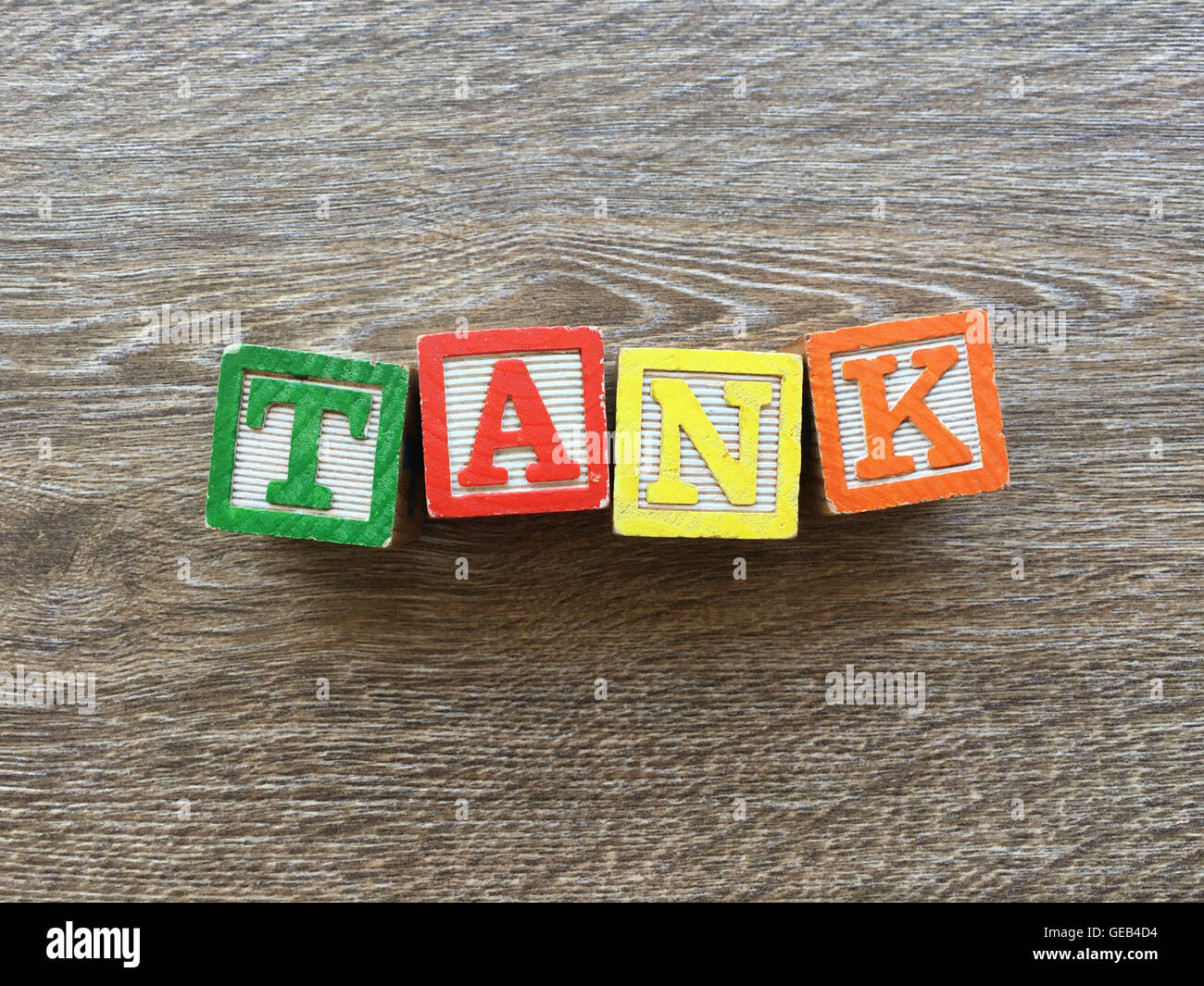 Alphabet wood block letters forming the word TANK, combining those toys ...