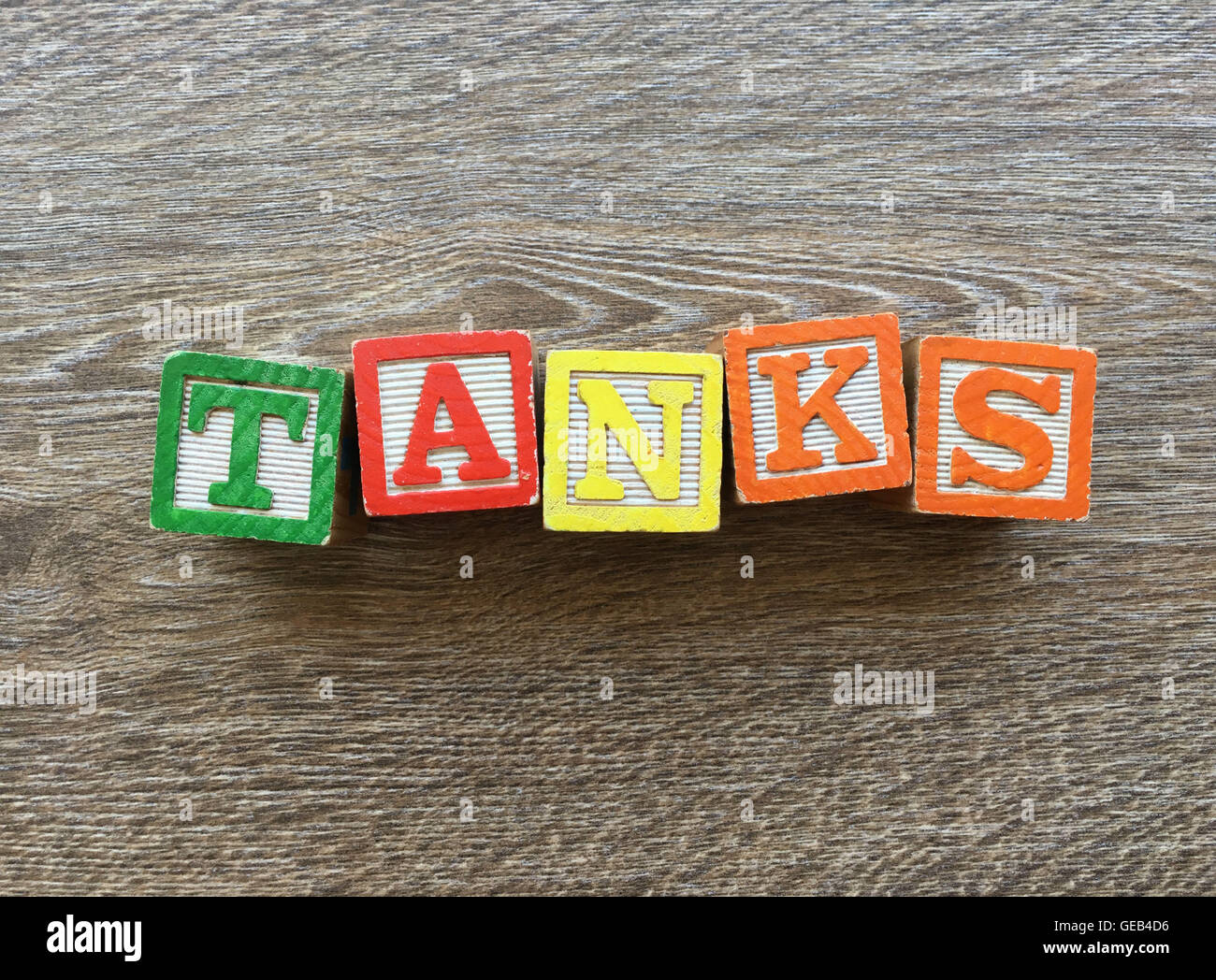 Alphabet wood block letters forming the word TANKS , combining those ...