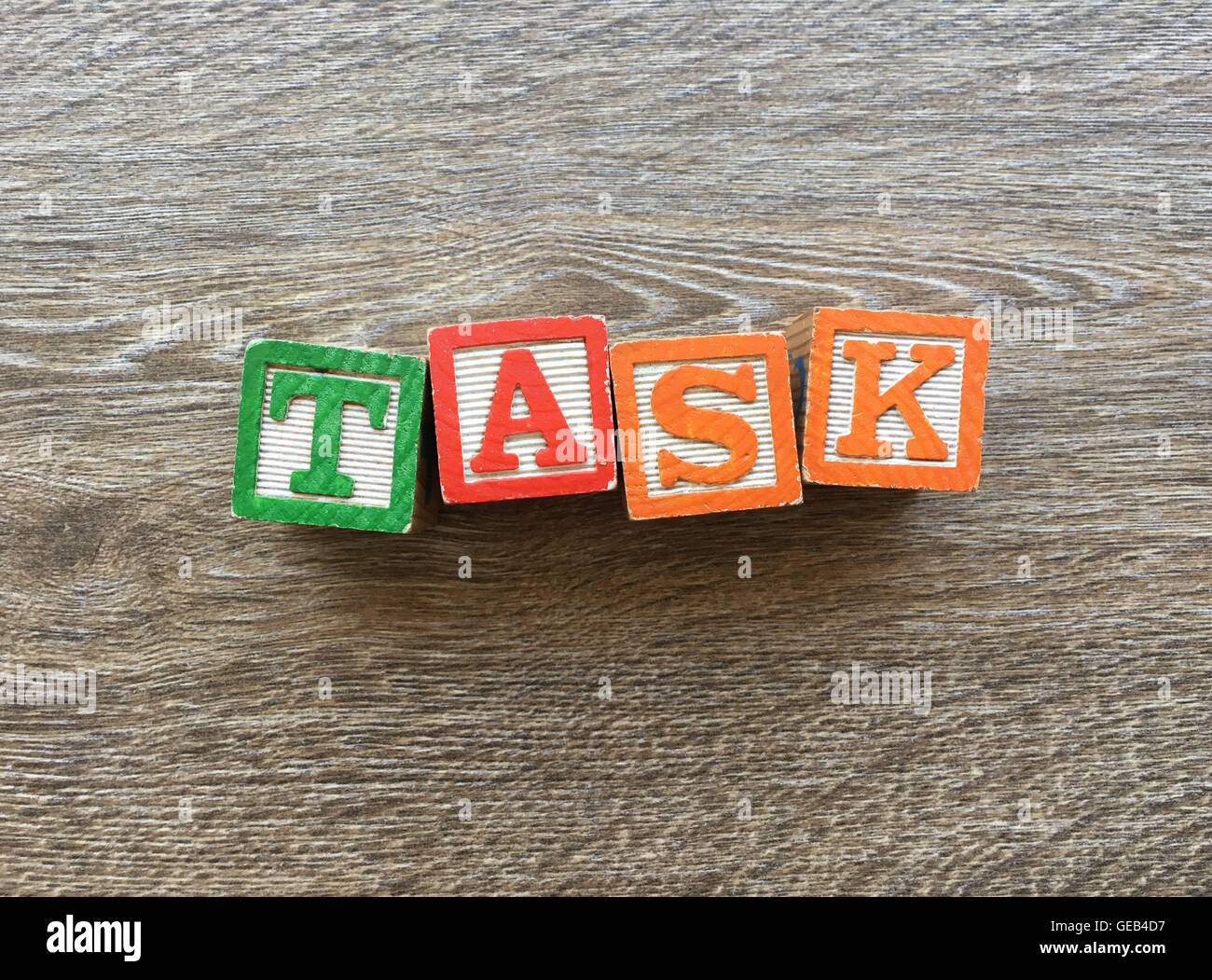 Alphabet wood block letters forming the word TASK, combining those toys ...