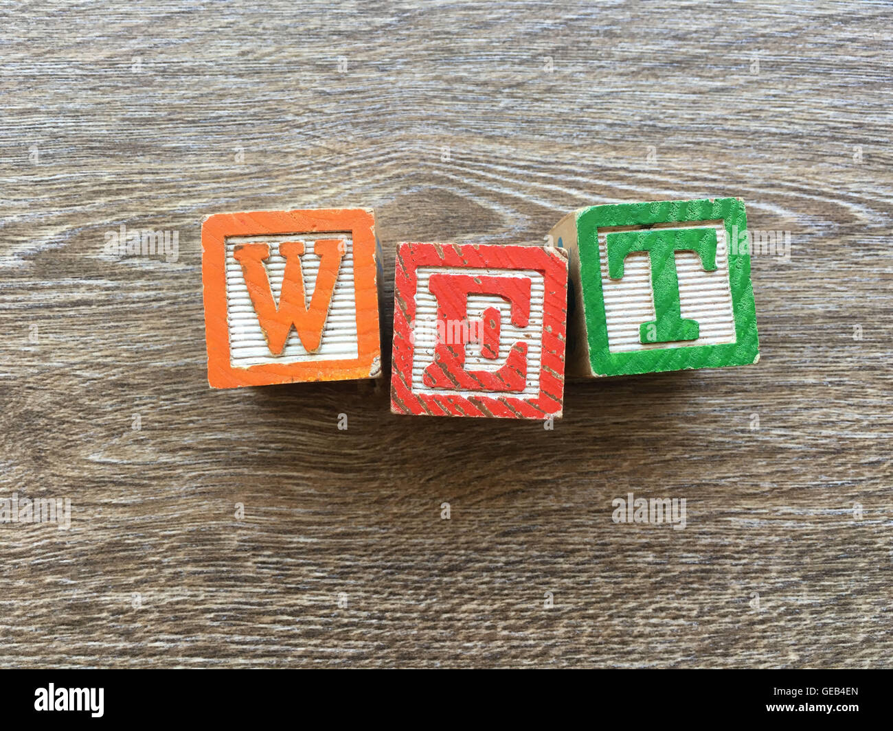 Alphabet wood block letters forming the word WET, combining those toys ...