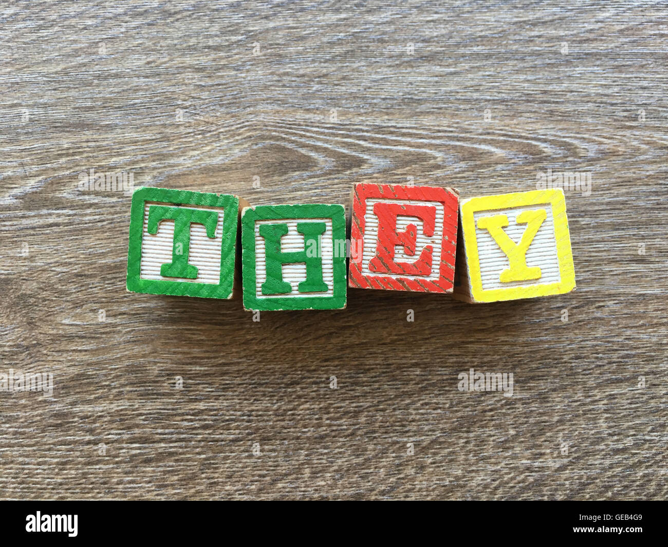 Alphabet wood block letters forming the word THEY, combining those toys ...