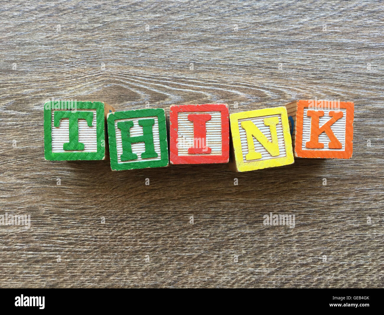 Alphabet wood block letters forming the word THINK, combining those ...
