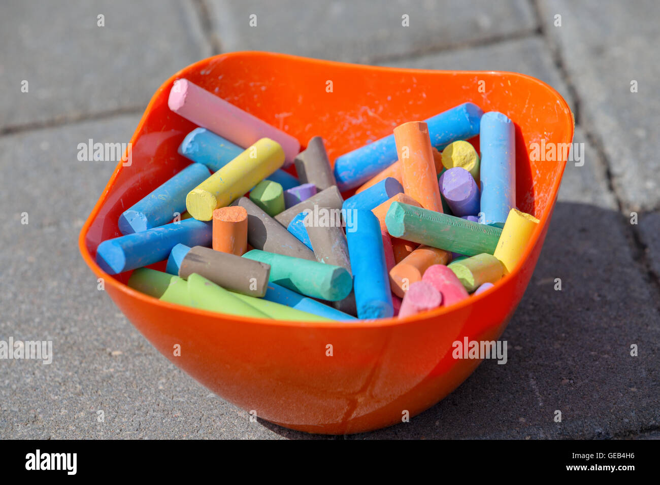 Different colored chalk in the orange cup Stock Photo - Alamy
