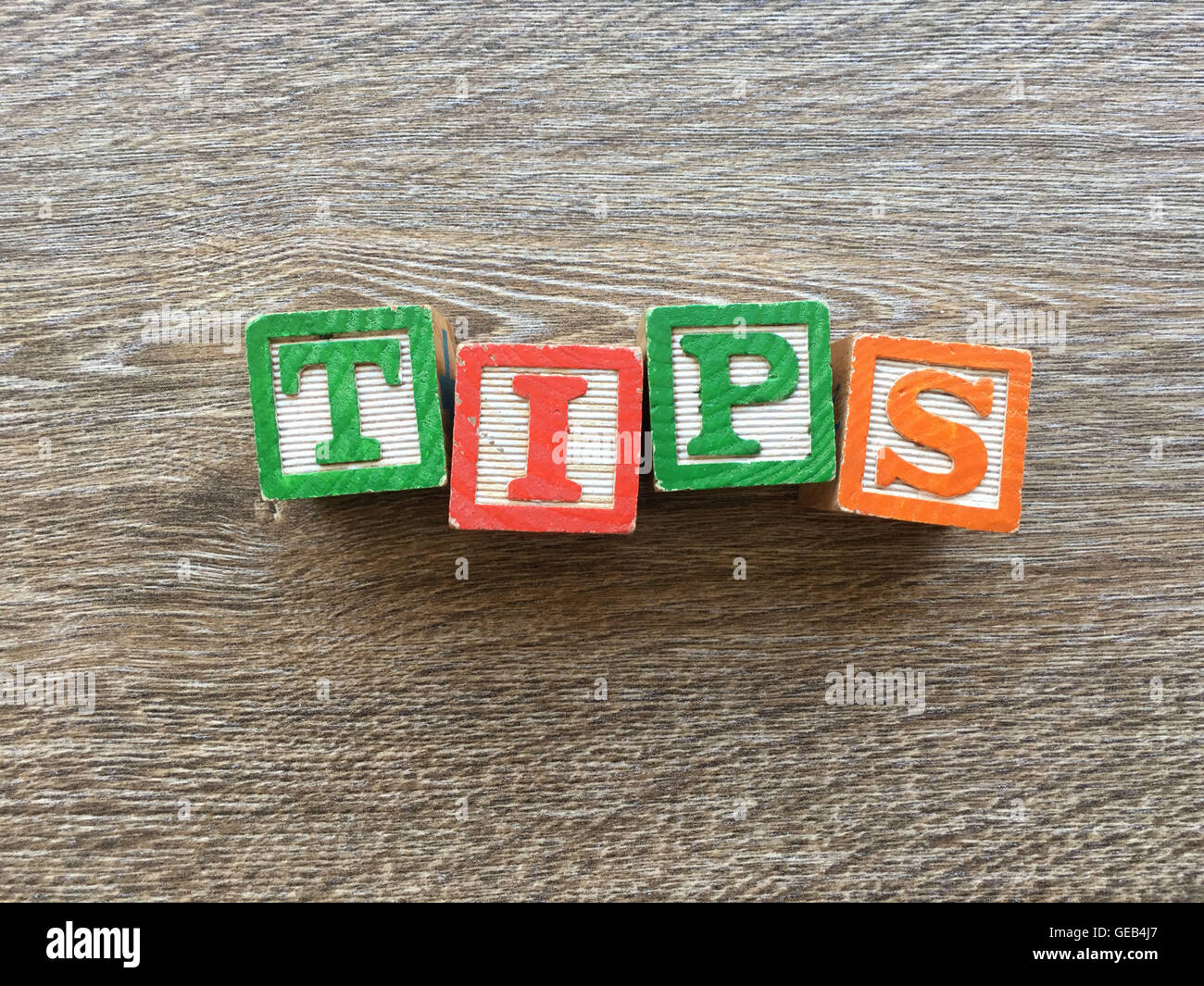 Alphabet wood block letters forming the word TIPS, combining those toys ...
