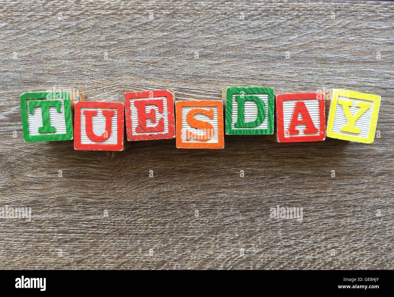 Alphabet wood block letters forming the word TUESDAY, combining those ...