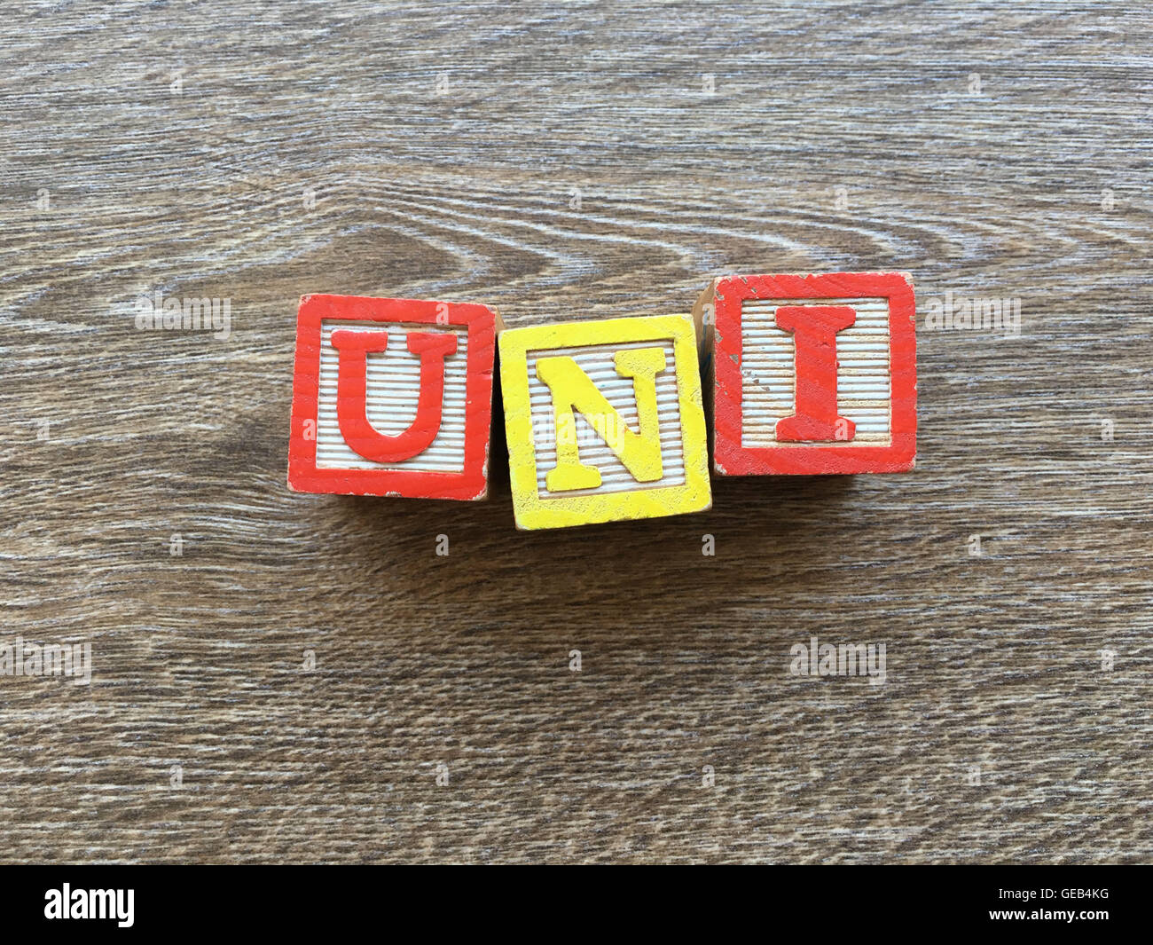 Alphabet wood block letters forming the word UNI, combining those toys ...