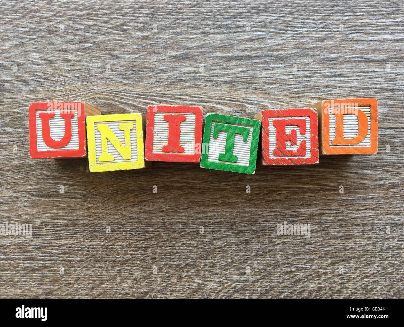 Alphabet wood block letters forming the word UNITED, combining those ...