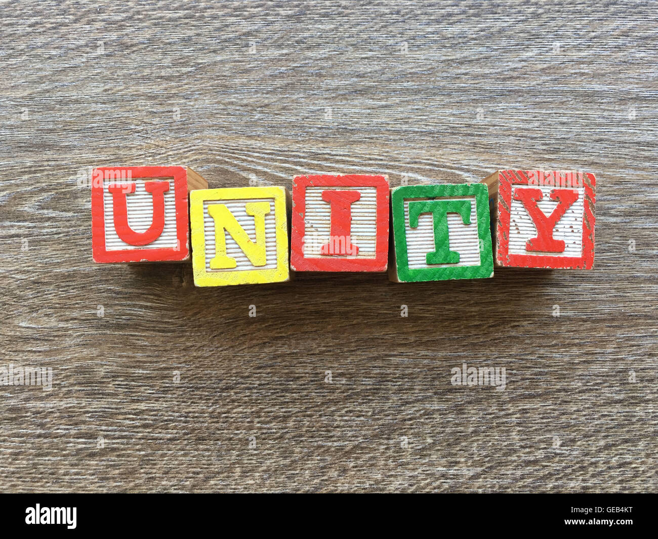 Alphabet wood block letters forming the word UNITY, combining those ...