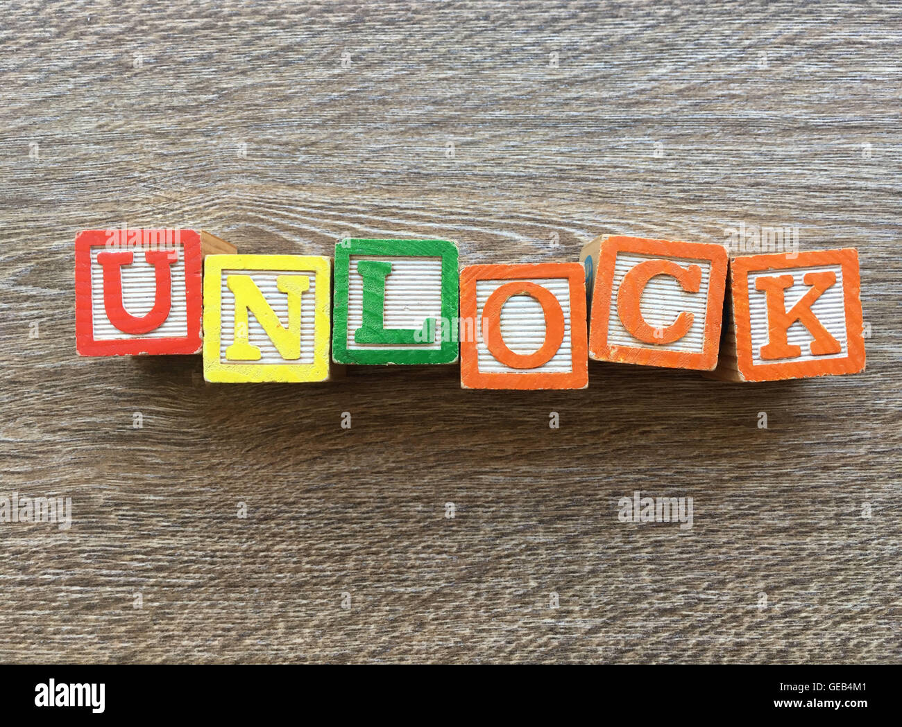 Alphabet wood block letters forming the word UNLOCK, combining those ...