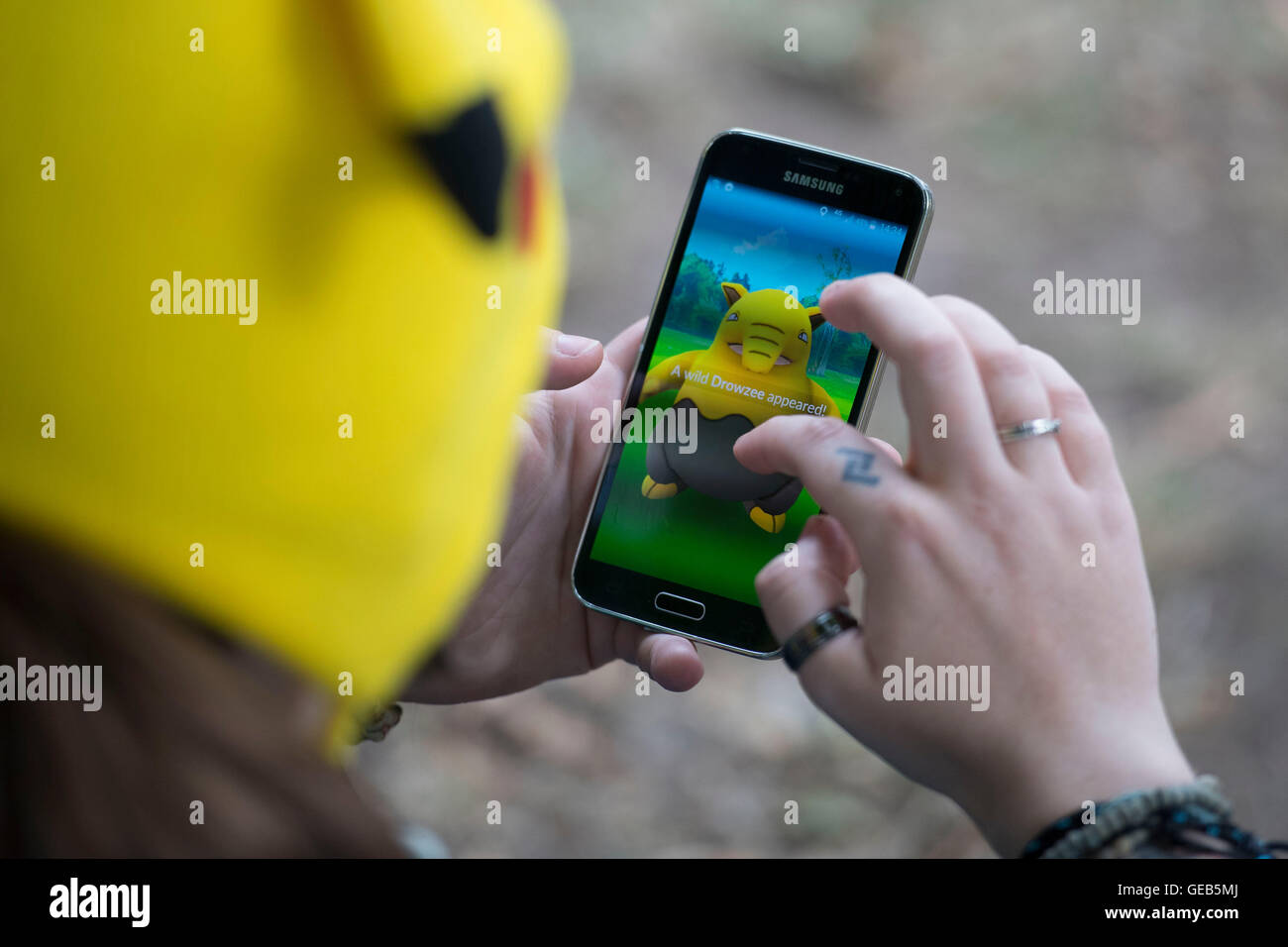 Pokemon GO players play Pokemon on their mobile phones in parks in ...