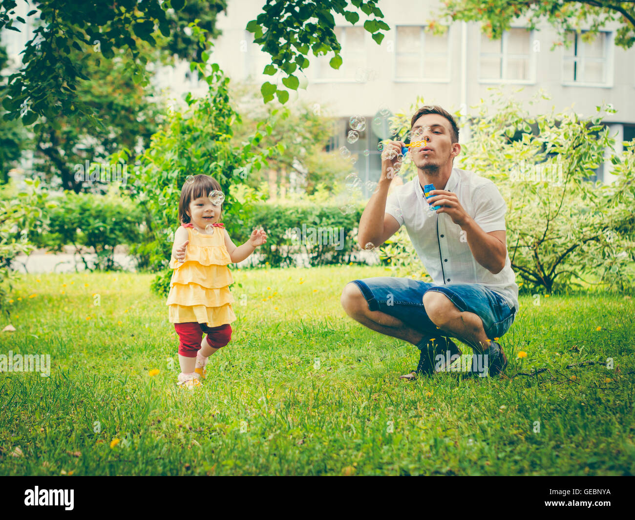 Dad and his daughter are making bubbles Stock Photo - Alamy