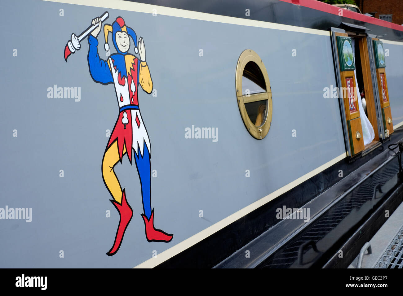 jester painted onto the side of a narrow boat at whilton marina near ...