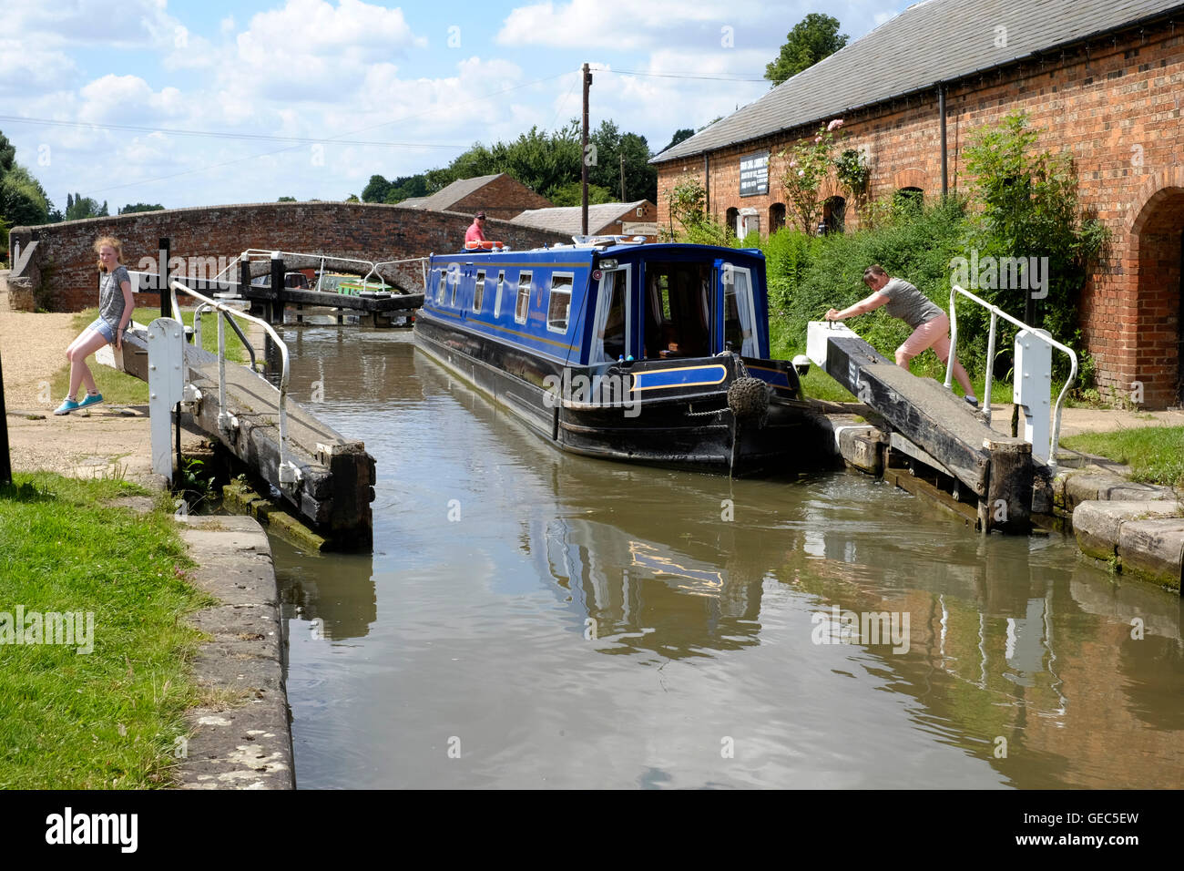 a female and young girl operating lock gates at braunston ...