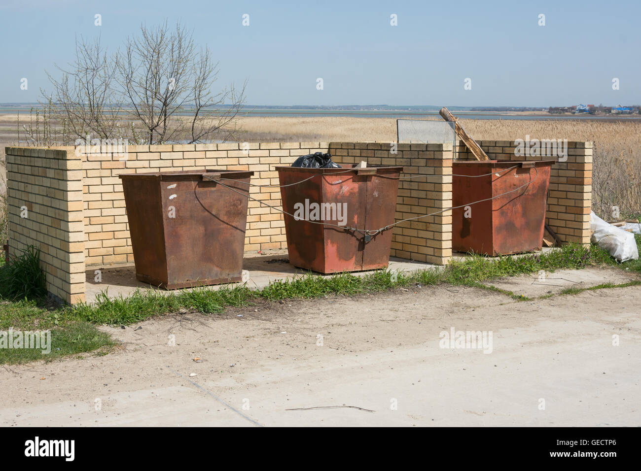 Three garbage tank linked metal cable are at the designated place and ...