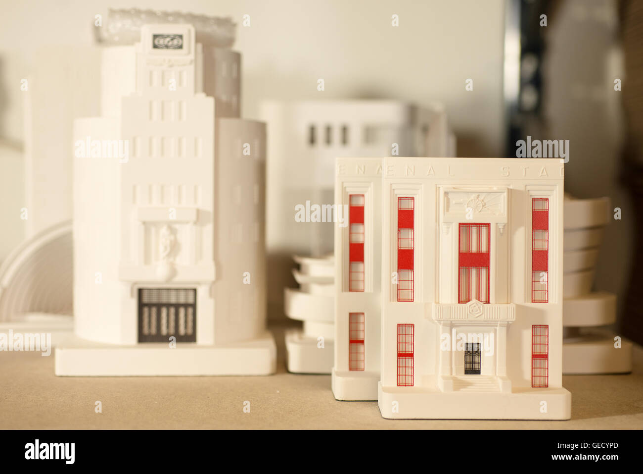 Plaster scale models of well-known architectural buildings on a wooden ...