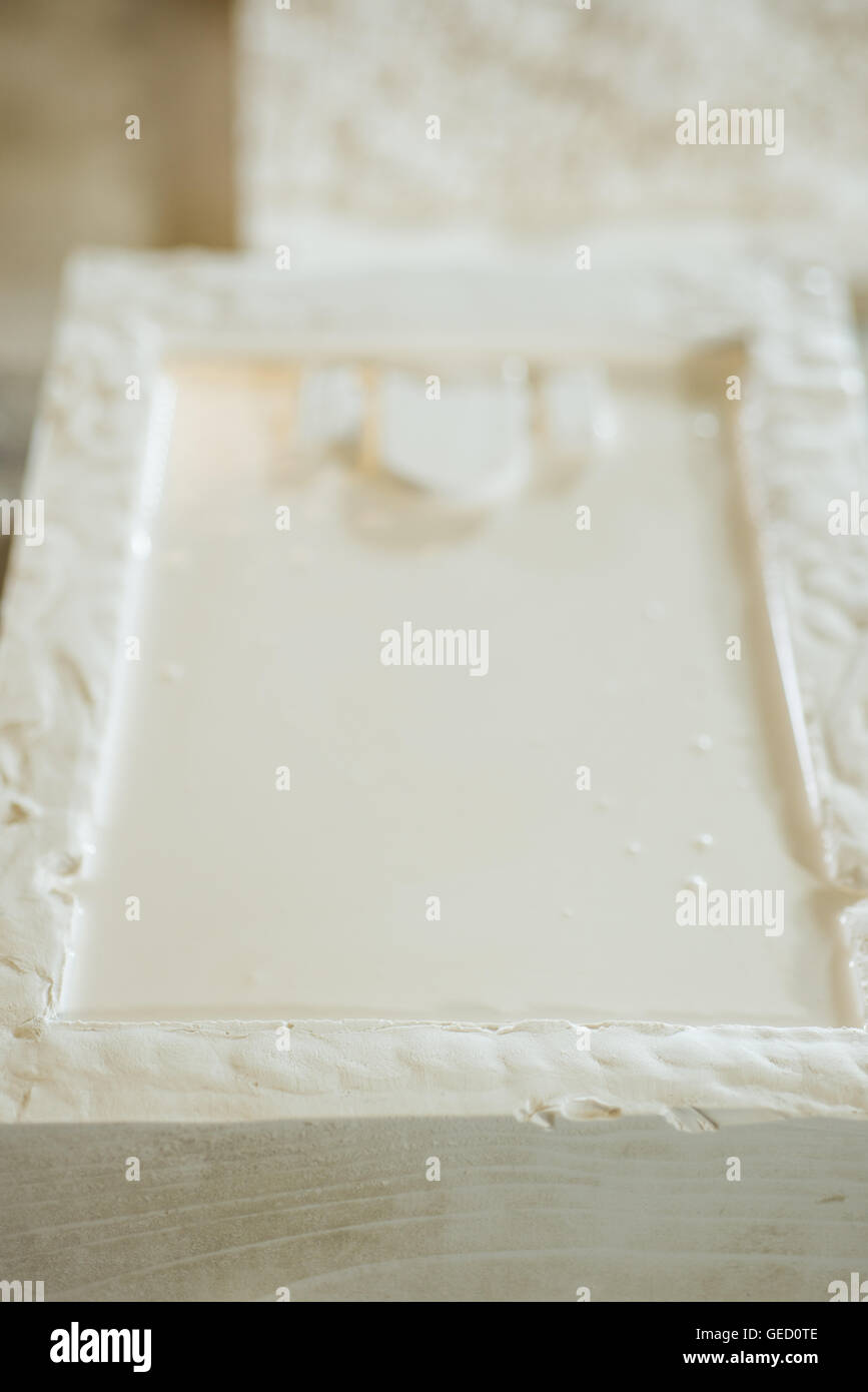 A small rectangular mold filled with plaster Stock Photo - Alamy