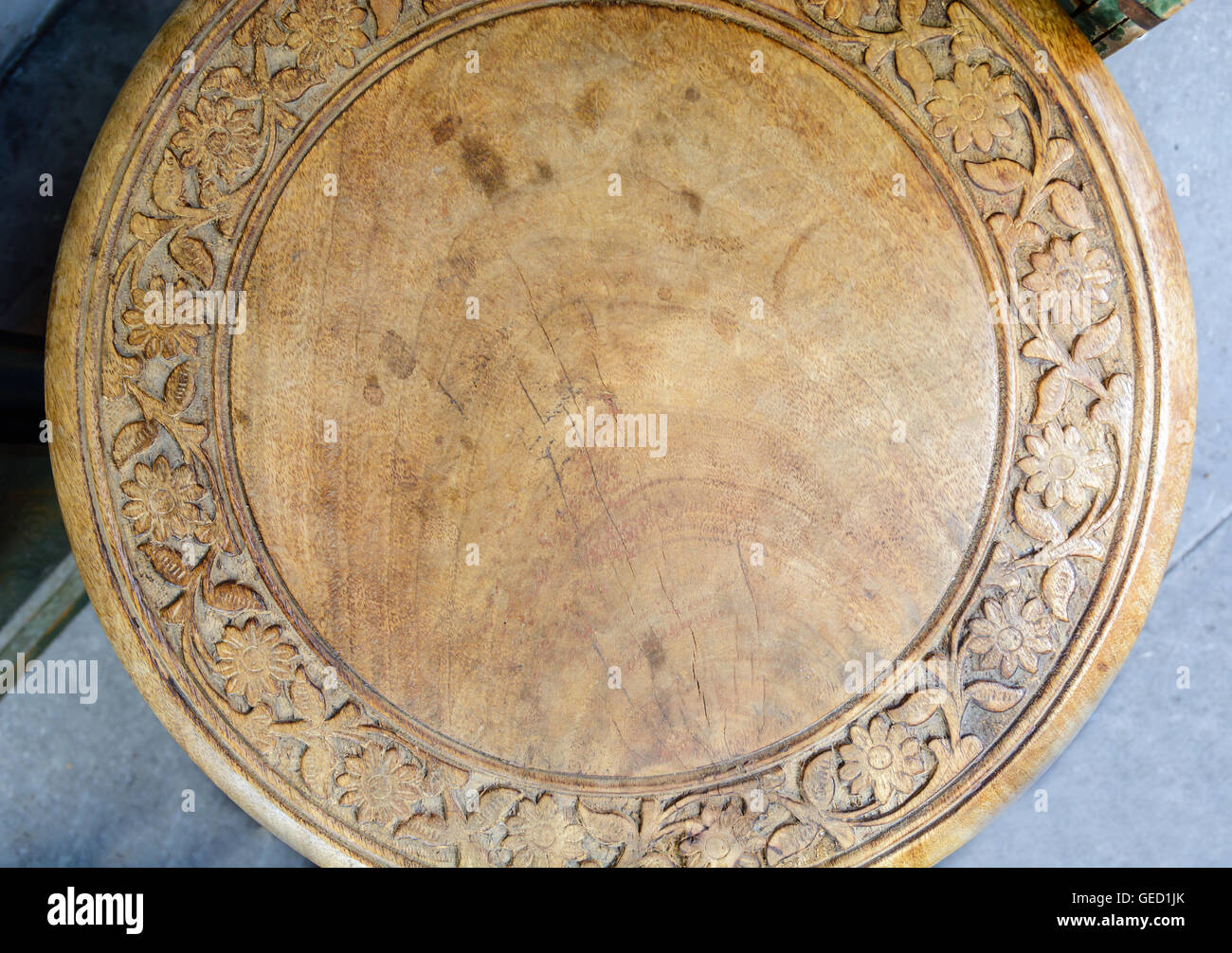 Round wooden table with decorative carvings around the edge. wood ...