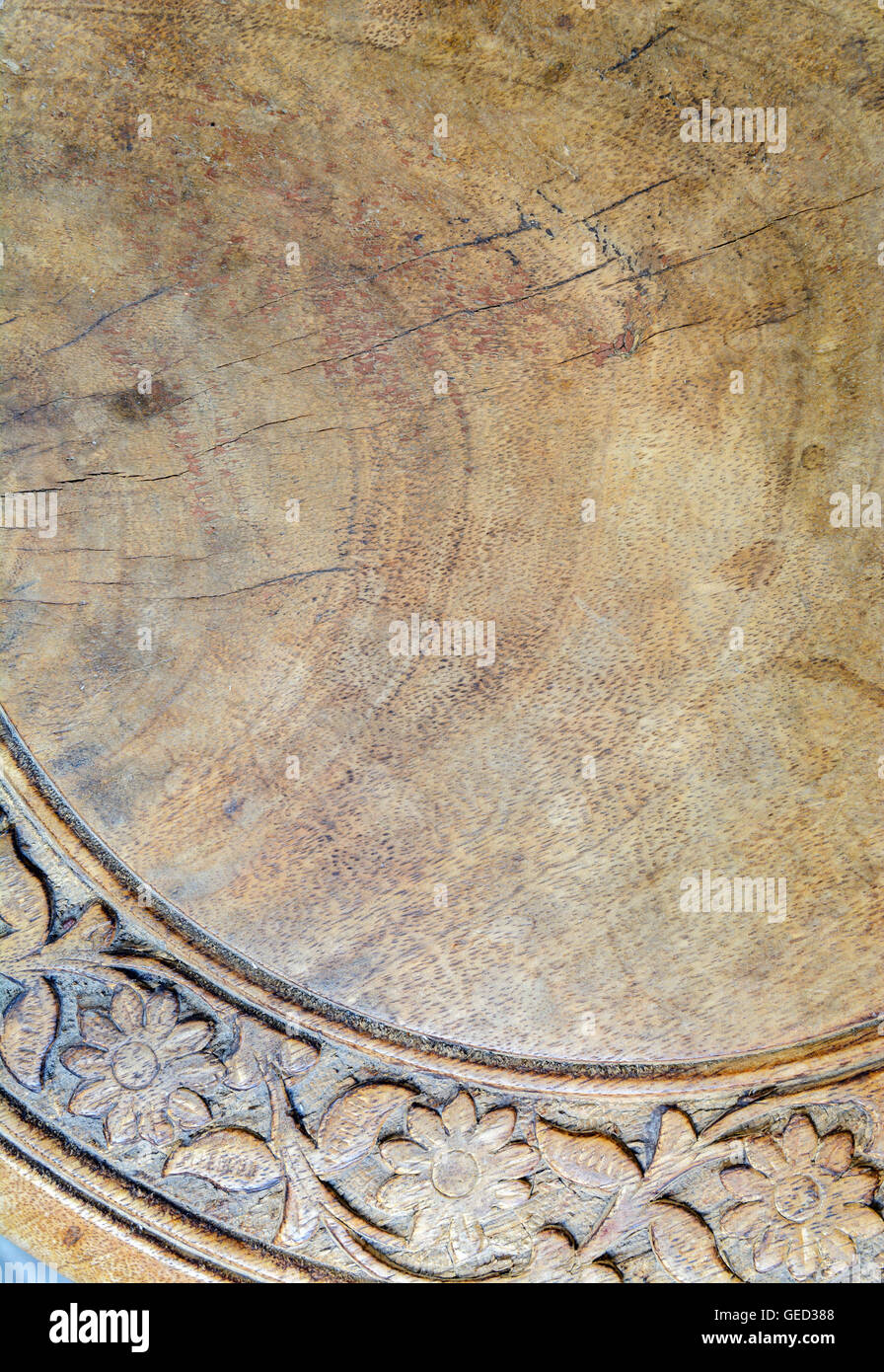 Round wooden table with decorative carvings around the edge. wood ...