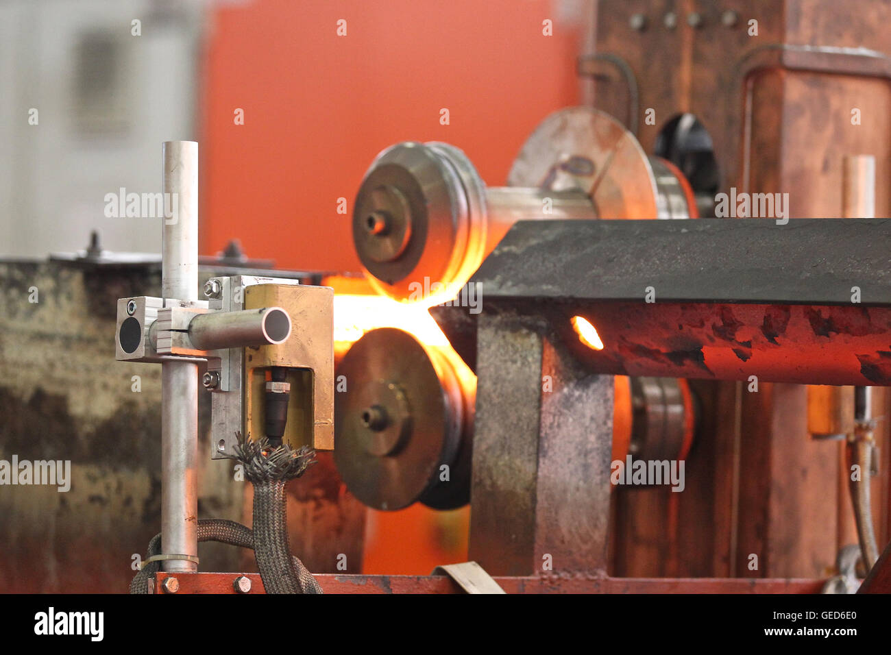 Moving the heated metal rod through the rollers in rolling mill Stock ...