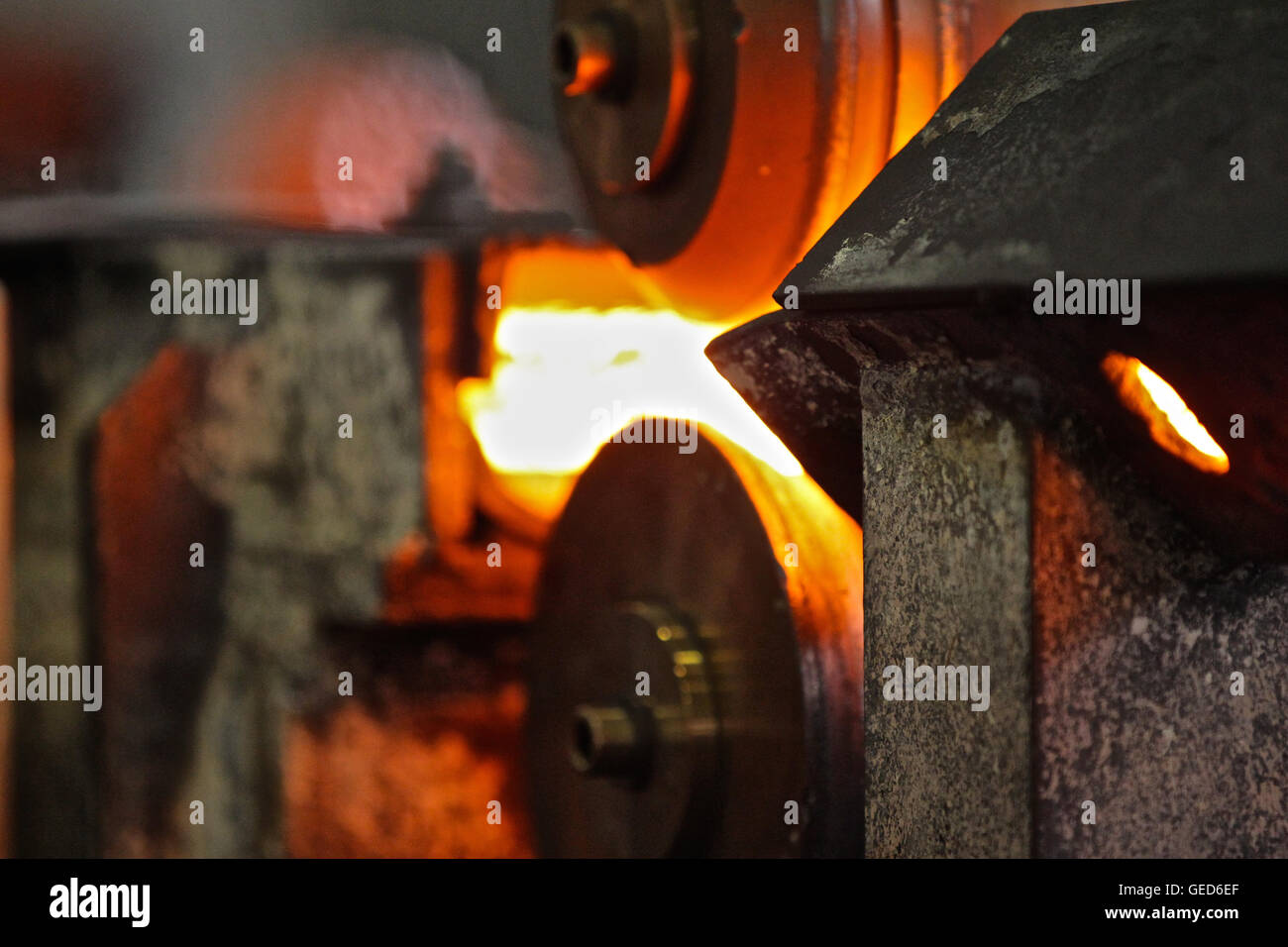 Moving the heated metal rod through the rollers in rolling mill Stock ...