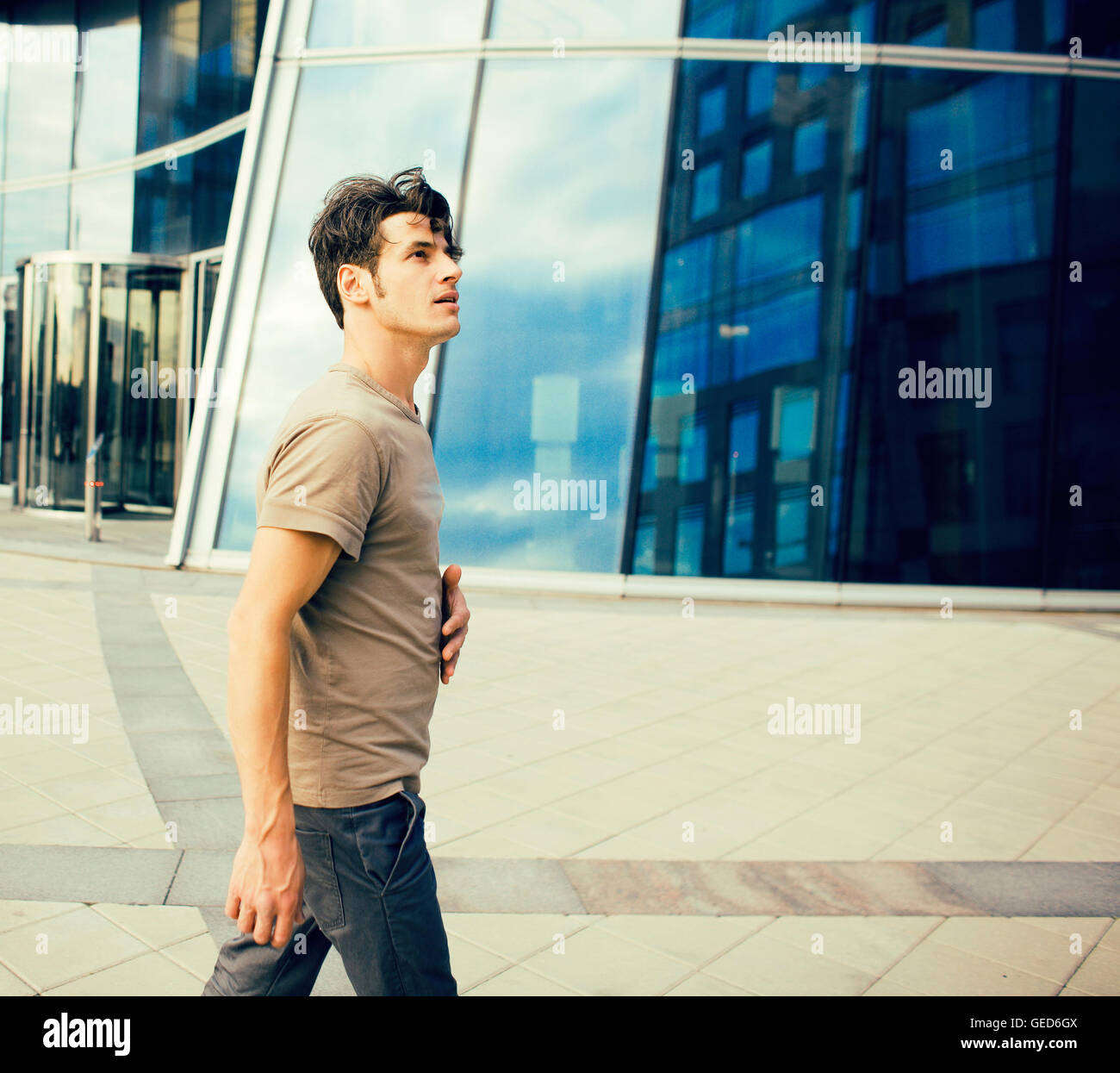 real young man stand in front of modern business building Stock Photo ...