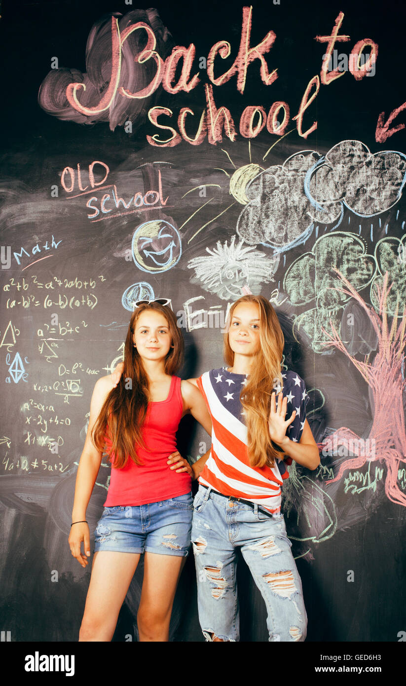 back to school after summer vacations, two teen real girls in classroom ...