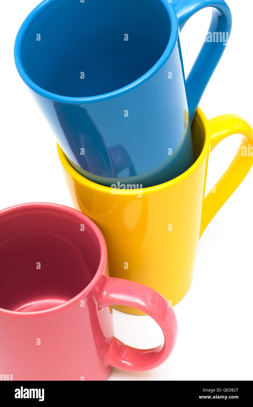 Beautiful color cups on a white background Stock Photo - Alamy