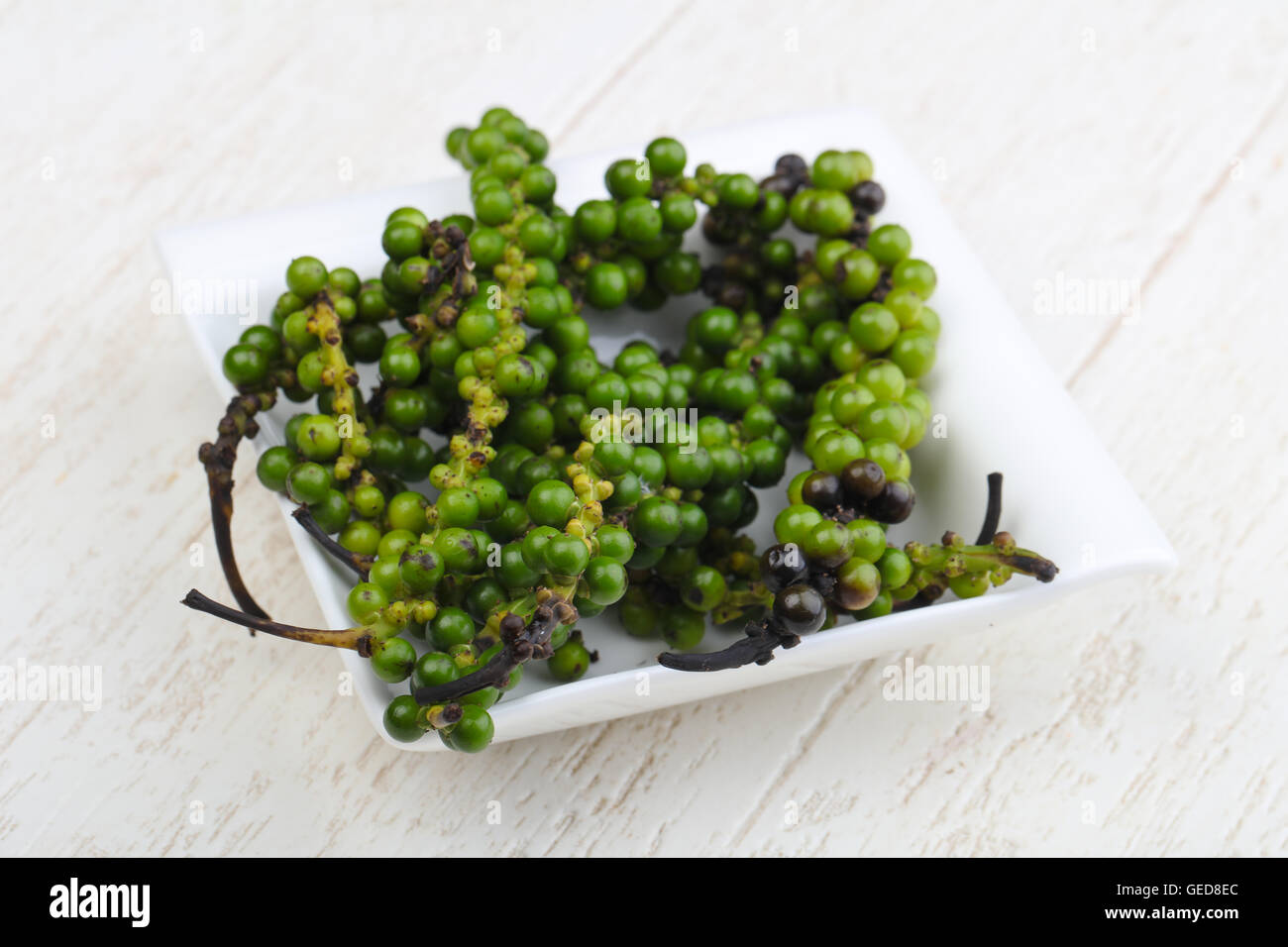 Green pepper corn on the branch in plate Stock Photo - Alamy
