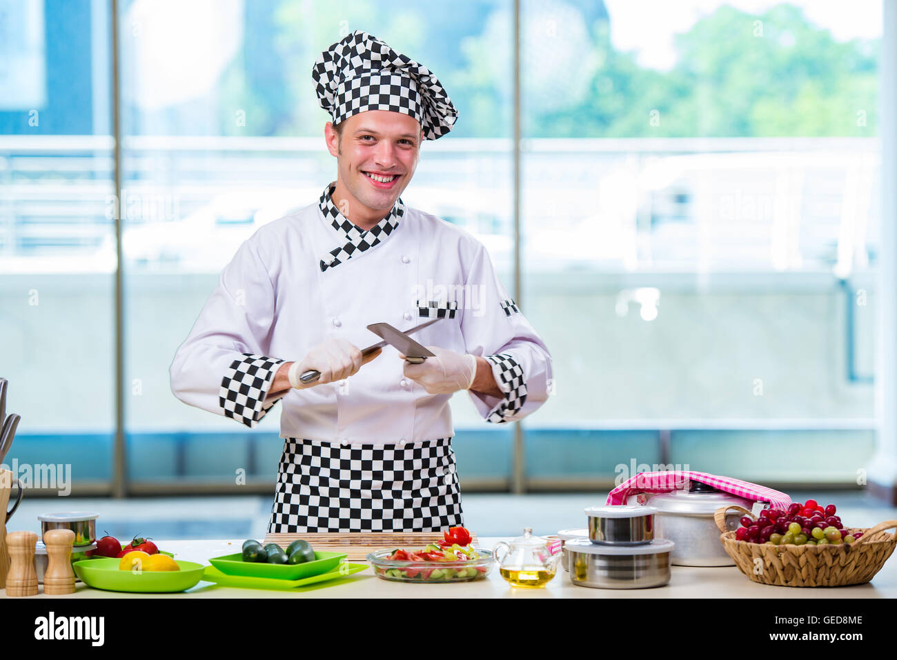Male cook preparing food in the kitchen Stock Photo - Alamy