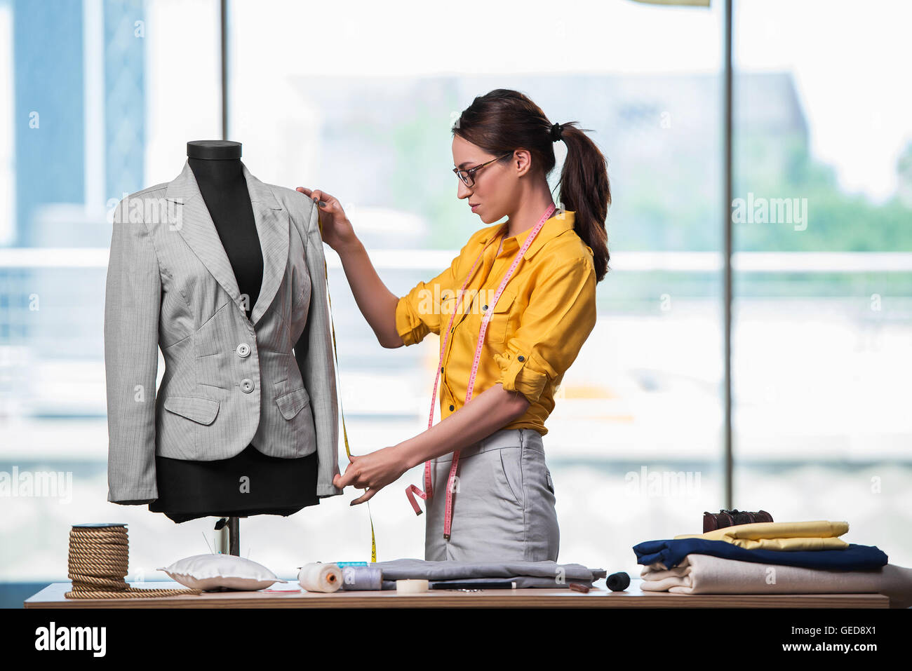 Woman tailor working on new clothing Stock Photo - Alamy