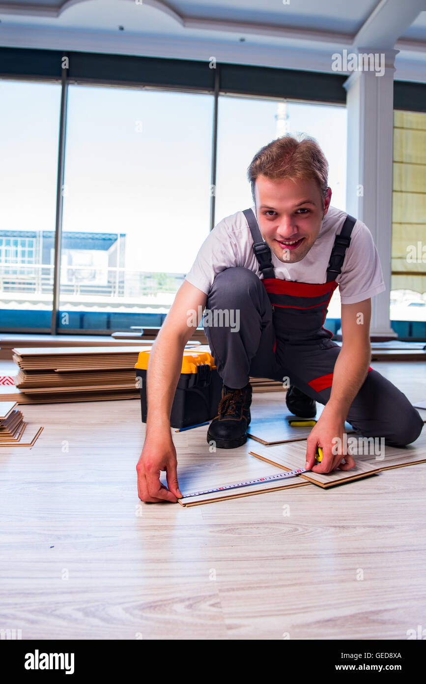 Man laying laminate flooring in construction concept Stock Photo - Alamy
