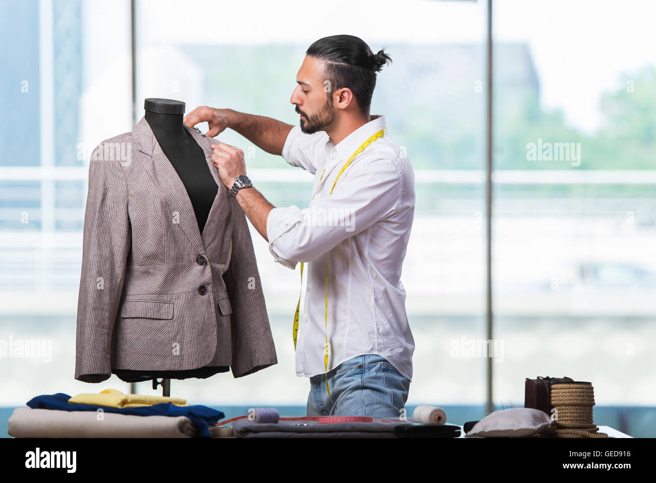 Young tailor working on new clothing design Stock Photo - Alamy