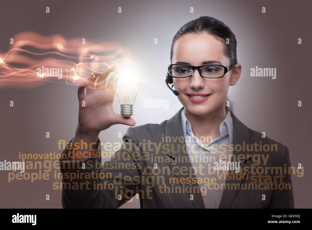Young call center operator with bulb in idea concept Stock Photo - Alamy